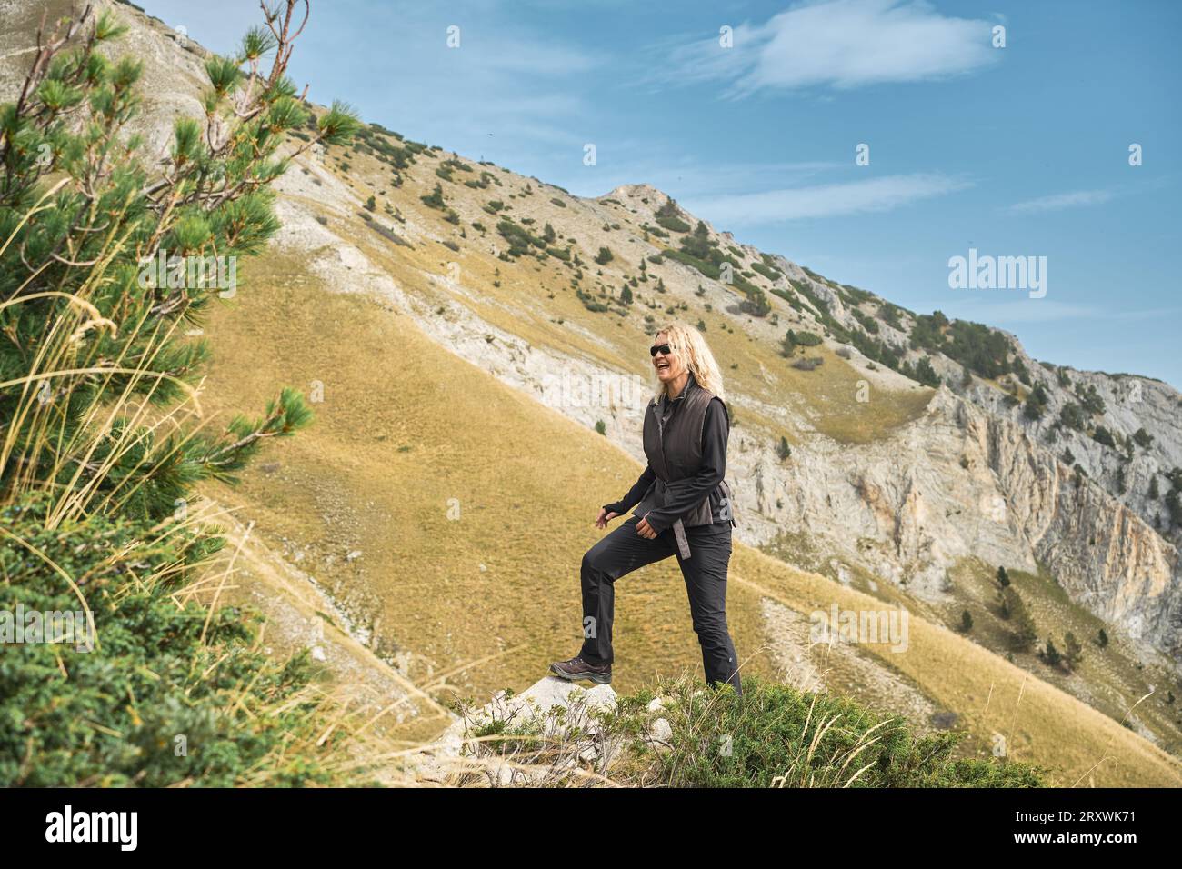 An adult woman during hike in mountains, active recreation in popular ...