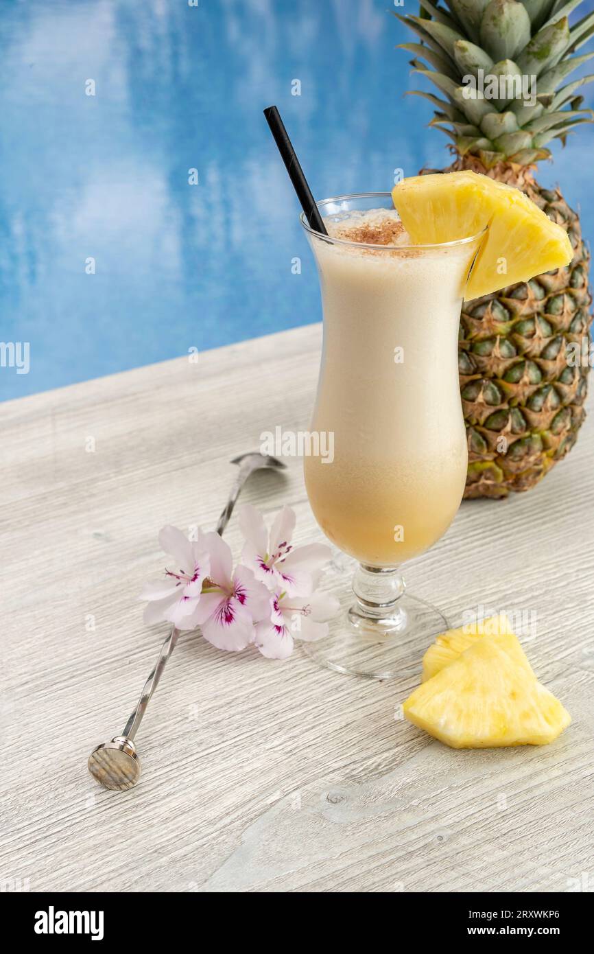Summer Cocktail, Piña colada. On a white table outdoor, decorated with ...