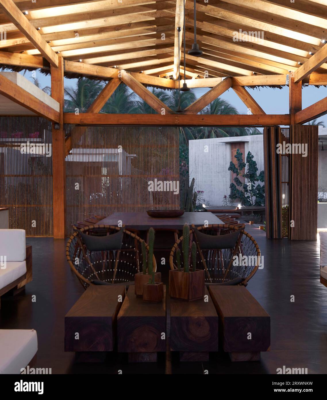 Dusk view with palapa roof ceiling and bedroom module units beyond ...