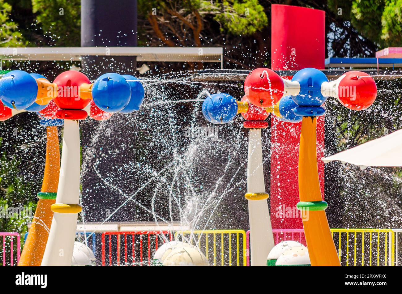Colorful Water Splashing Pad in an Aqua Park. Fountain Shoots Water and ...