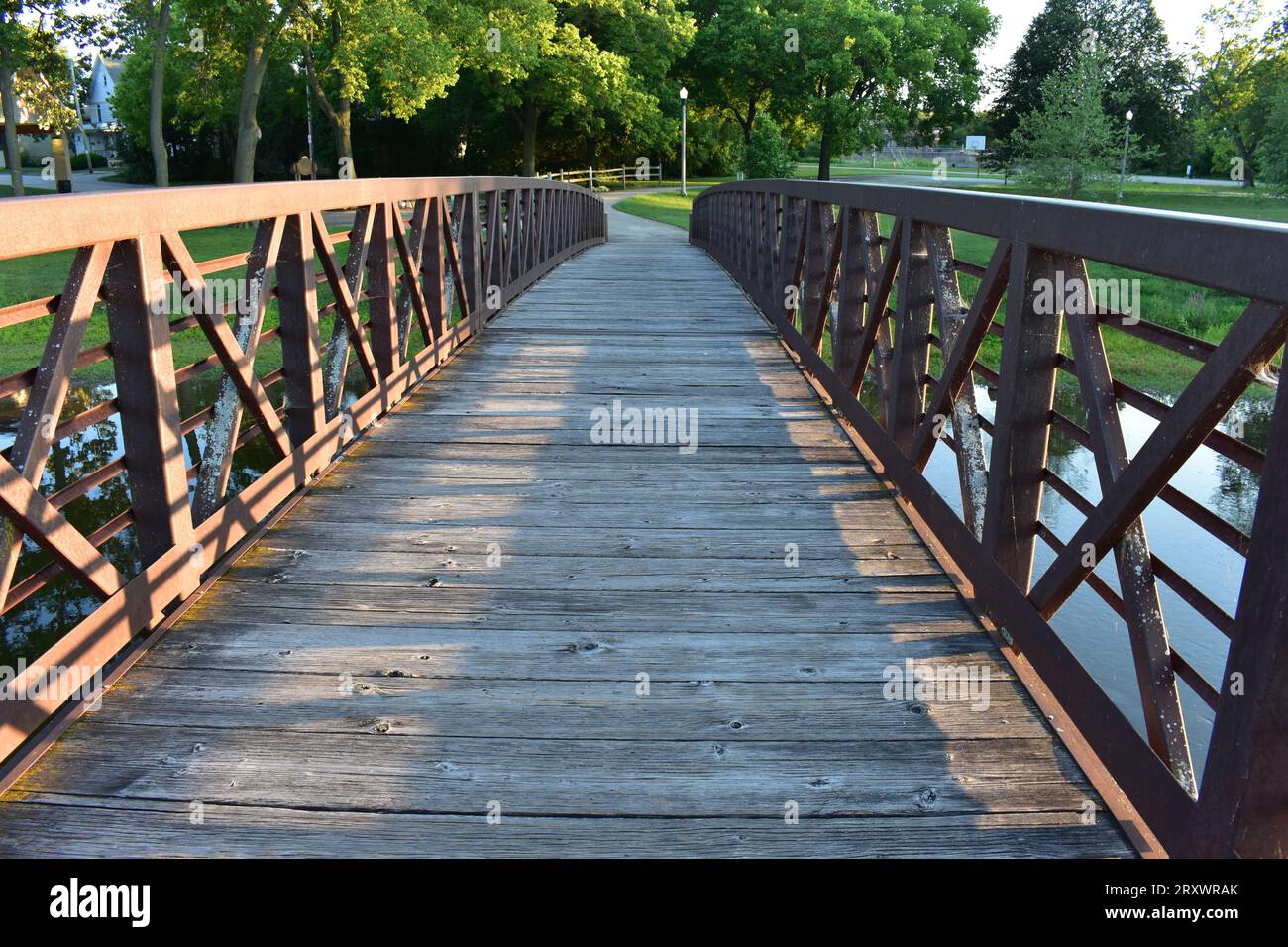 Walking across Fox River on Bridge in Riverside Park, Burlington ...