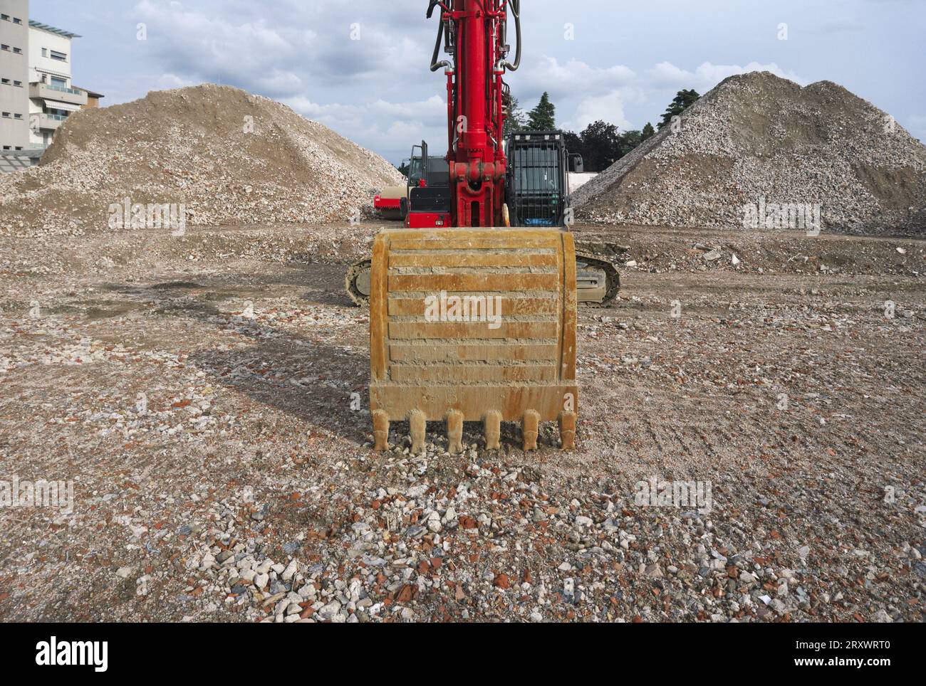 excavator and heaps of sand in construction site Stock Photo - Alamy