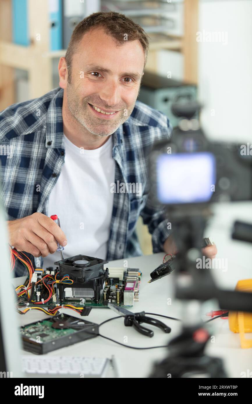 vlogger recording computer repair on camera for vlog blog Stock Photo ...