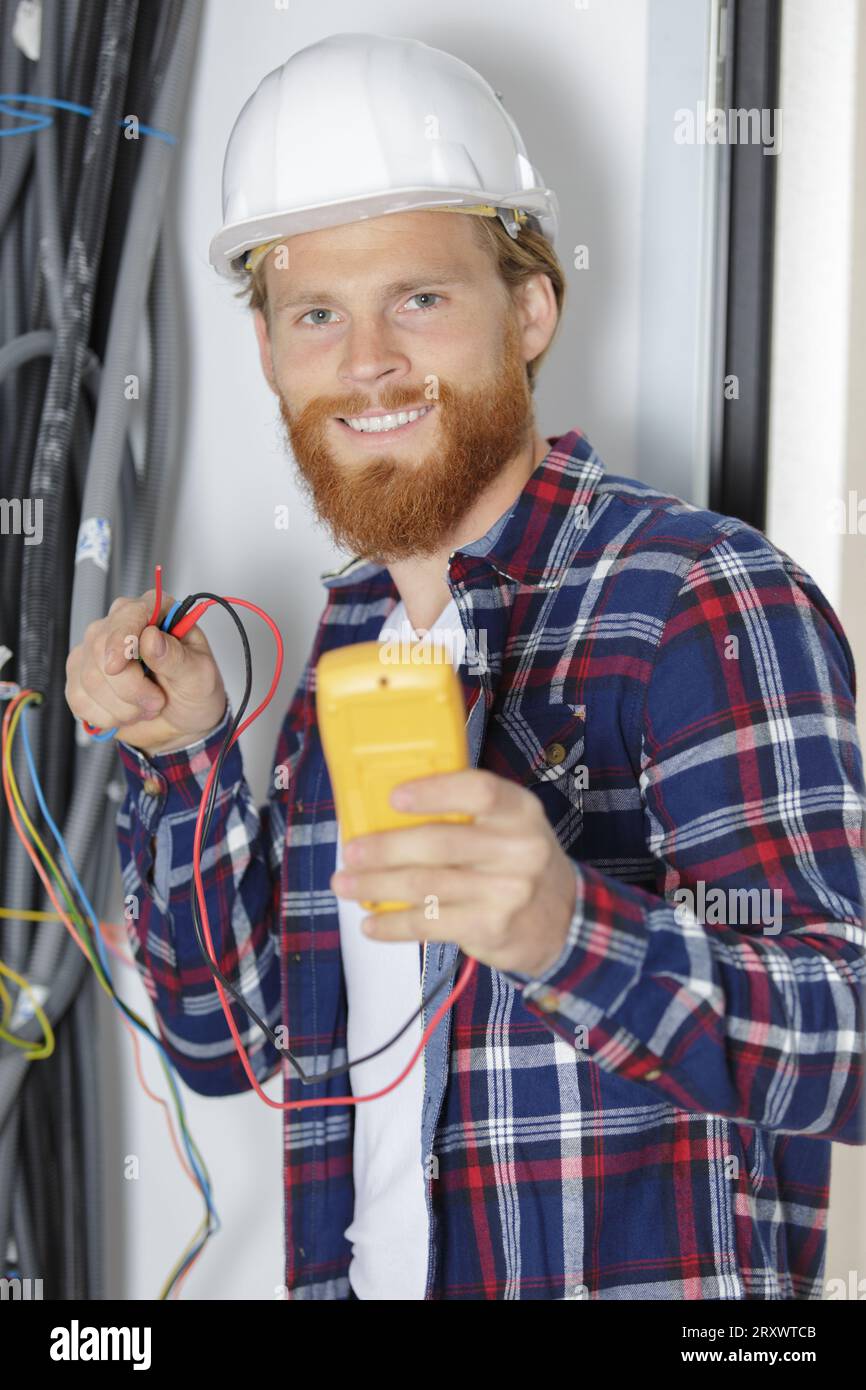 electrician at work measures the electric current Stock Photo - Alamy