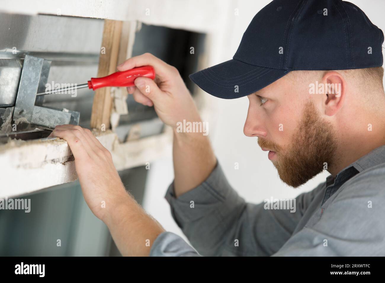 man fixing a metal bracket to the wall Stock Photo - Alamy