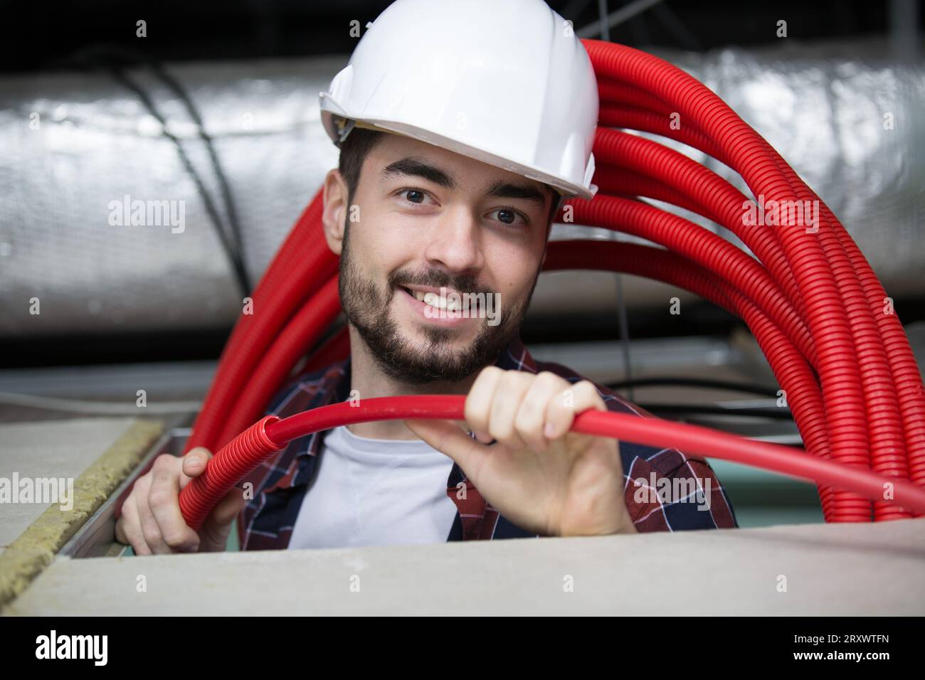 electrician wiring pipes in the ceiling Stock Photo - Alamy