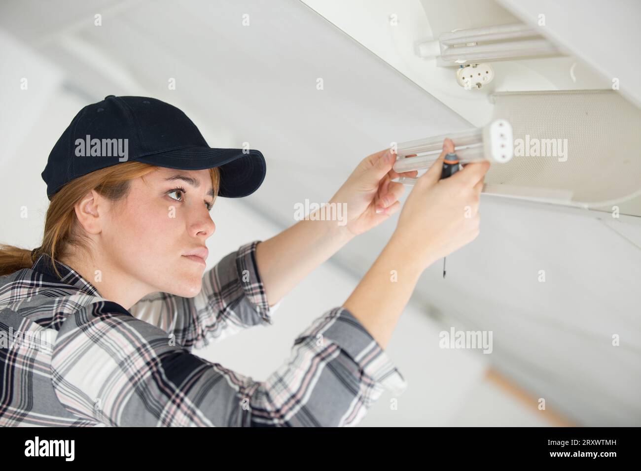 woman changing light bulb Stock Photo - Alamy