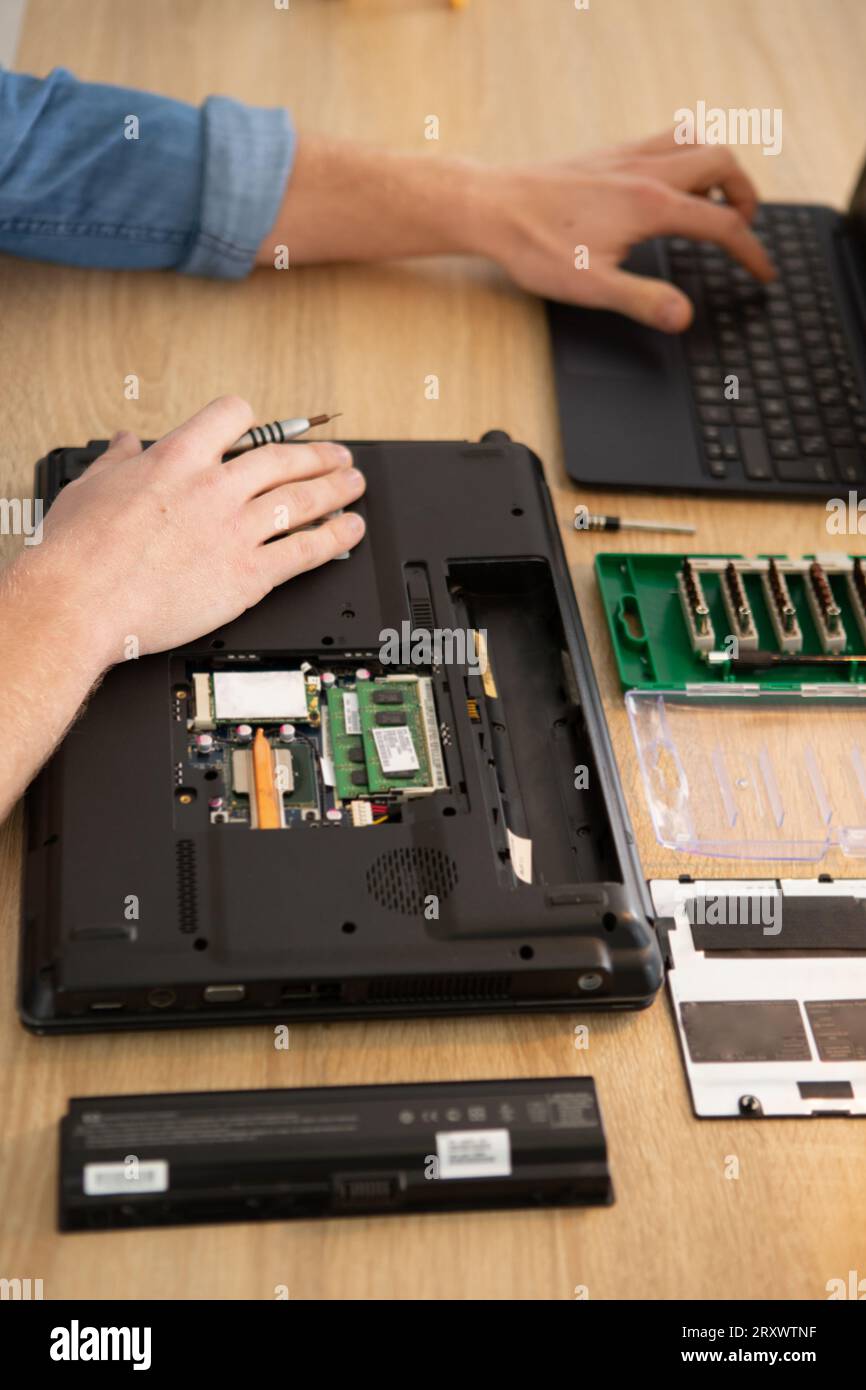 repairman working in technical support fixing computer laptop Stock ...