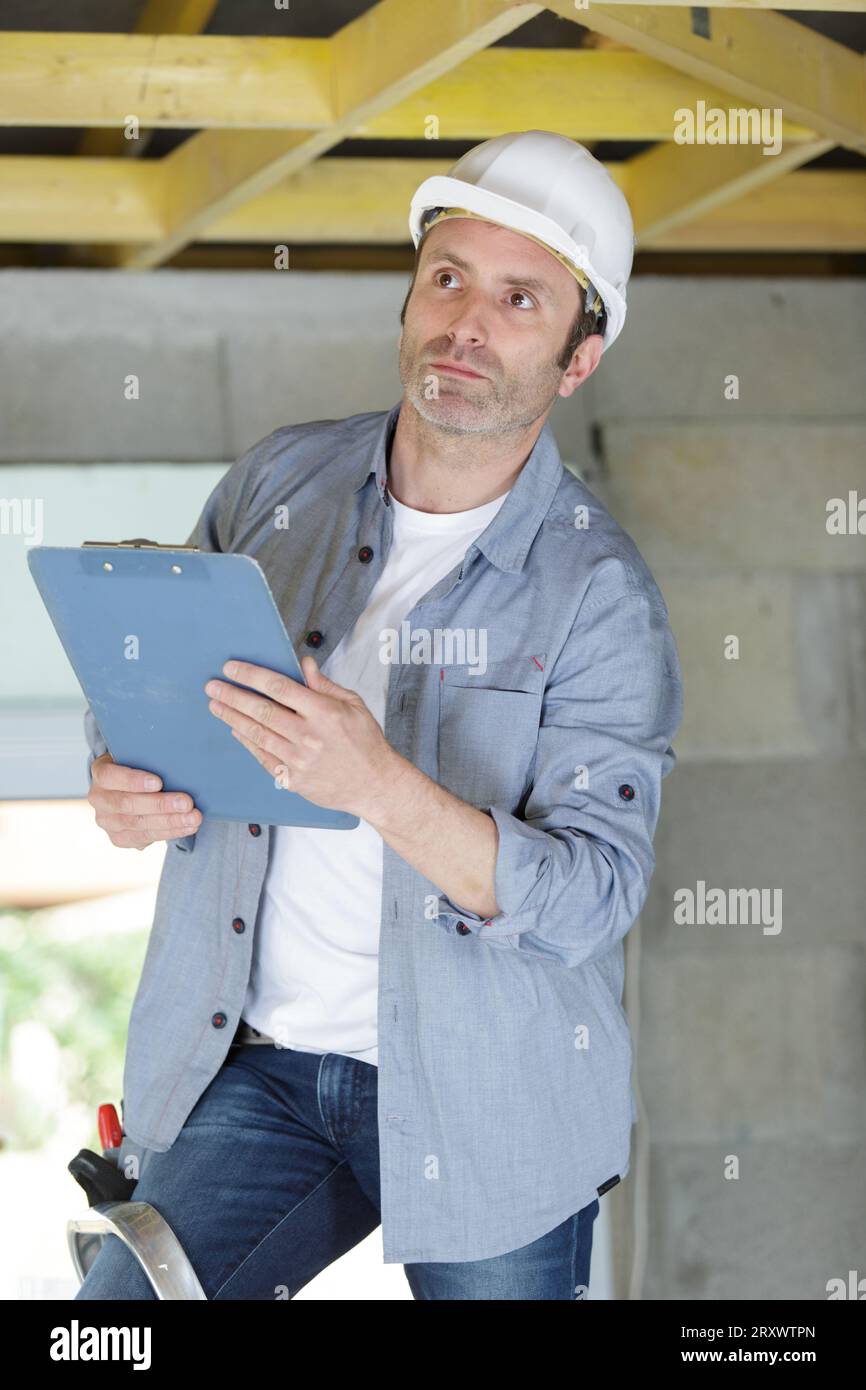 foreman in hard hat holding clipboard Stock Photo - Alamy