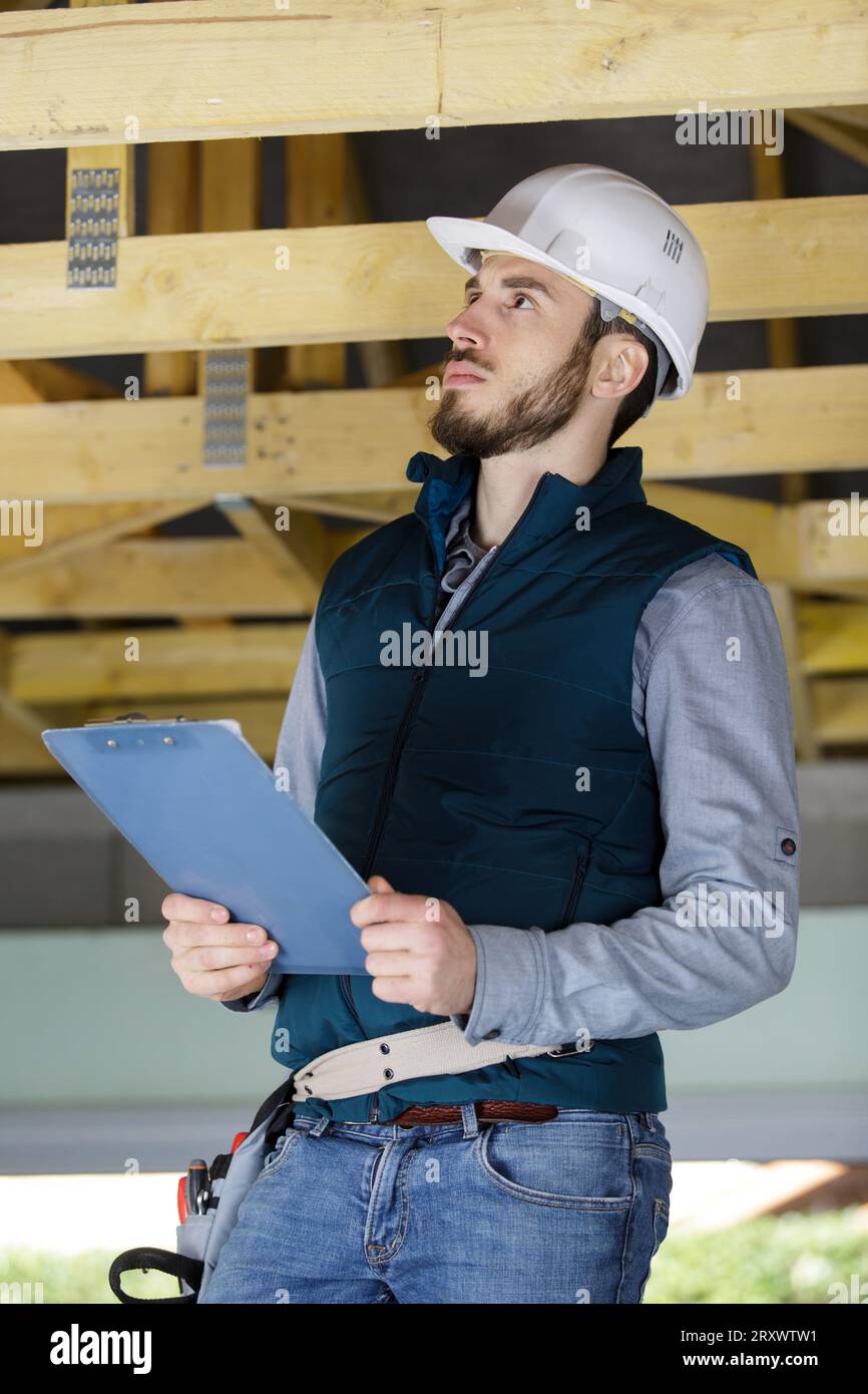 young constructor engineer man marking a wood structure Stock Photo - Alamy