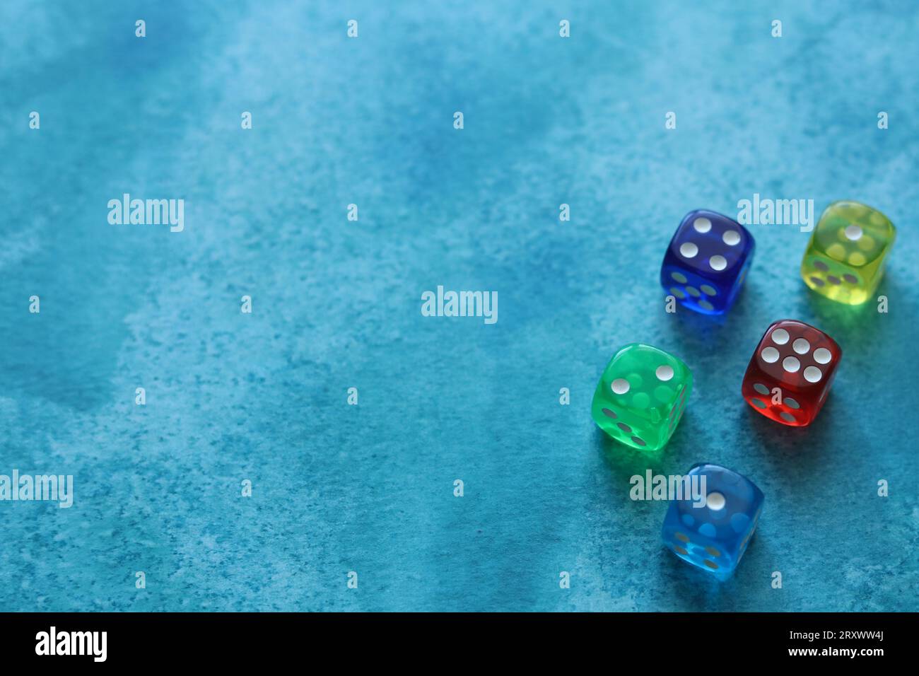set of colorful dice on a blue watercolor background Stock Photo - Alamy