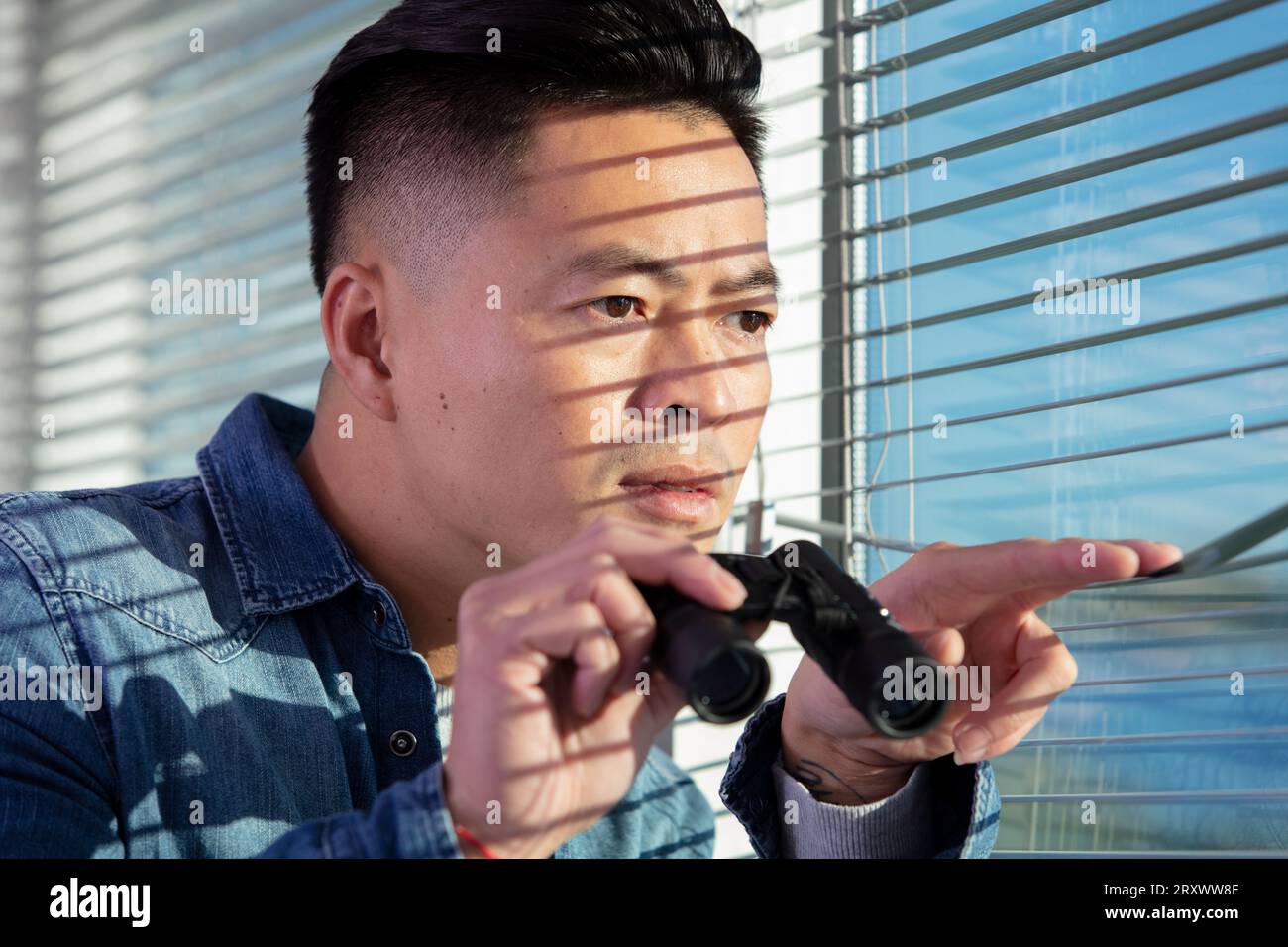 Man peeking out window hi-res stock photography and images - Alamy