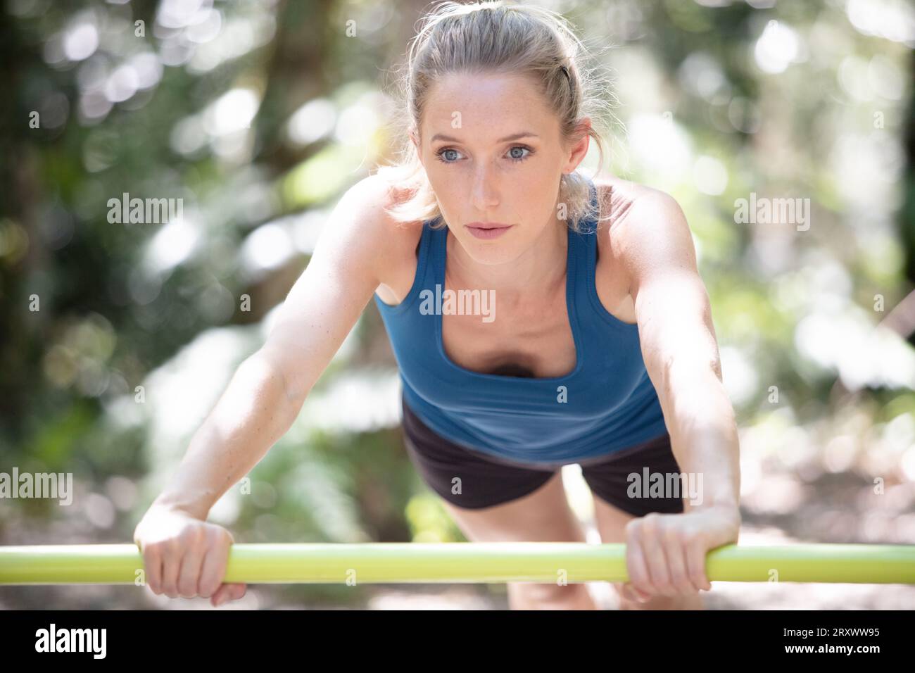 fit young woman doing triceps dips on parallel bars Stock Photo - Alamy