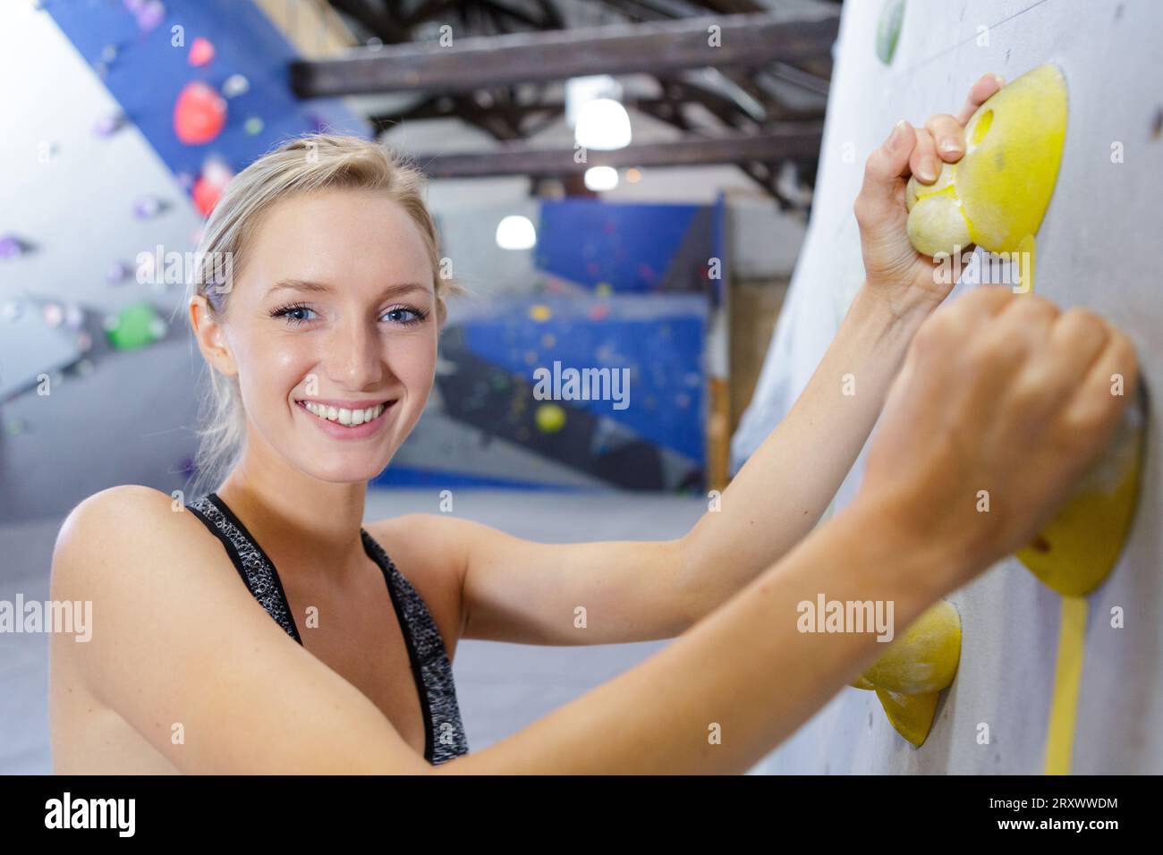 active happy woman in the artificial climbing wall Stock Photo - Alamy