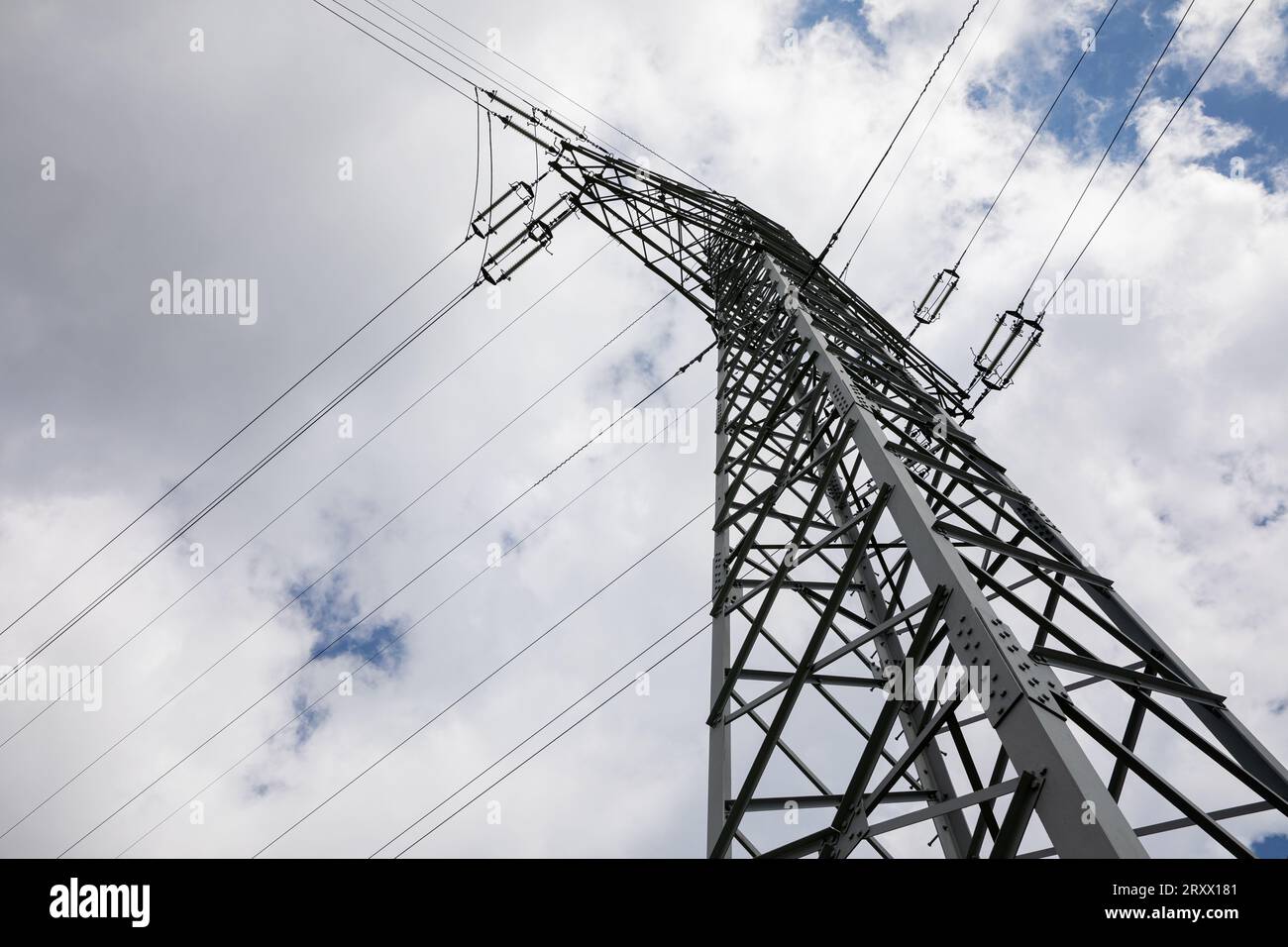 View from below of the tall poles of the high-voltage overhead line ...