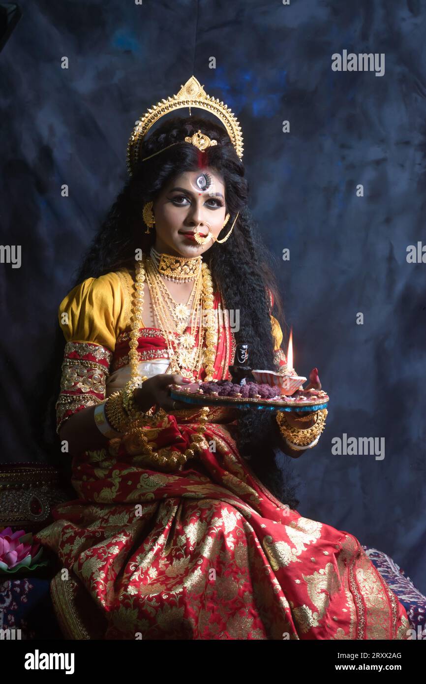 Portrait of beautiful Indian girl of Durga Idol Agomoni Concept Indoor ...