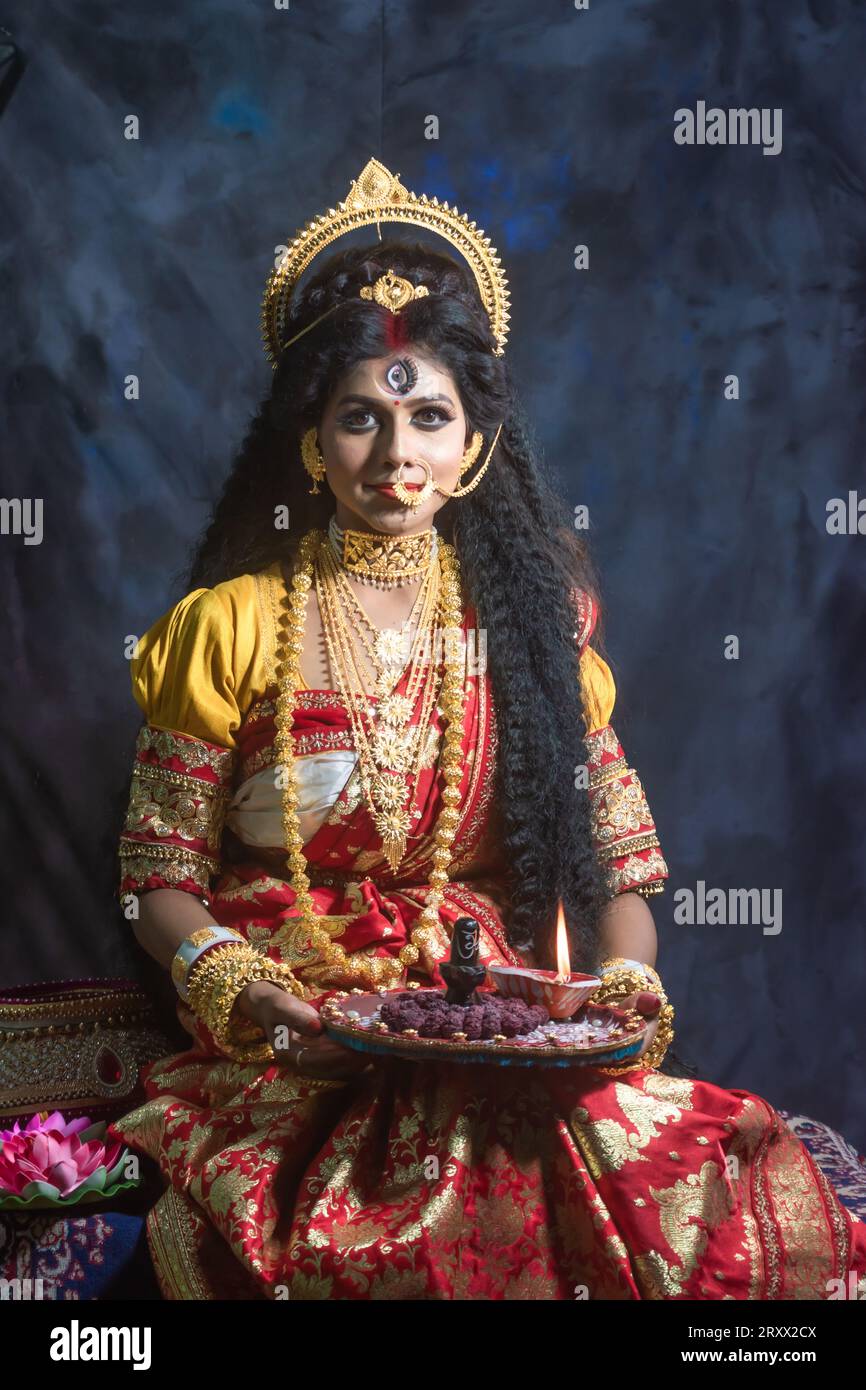 Portrait of beautiful Indian girl of Durga Idol Agomoni Concept Indoor ...