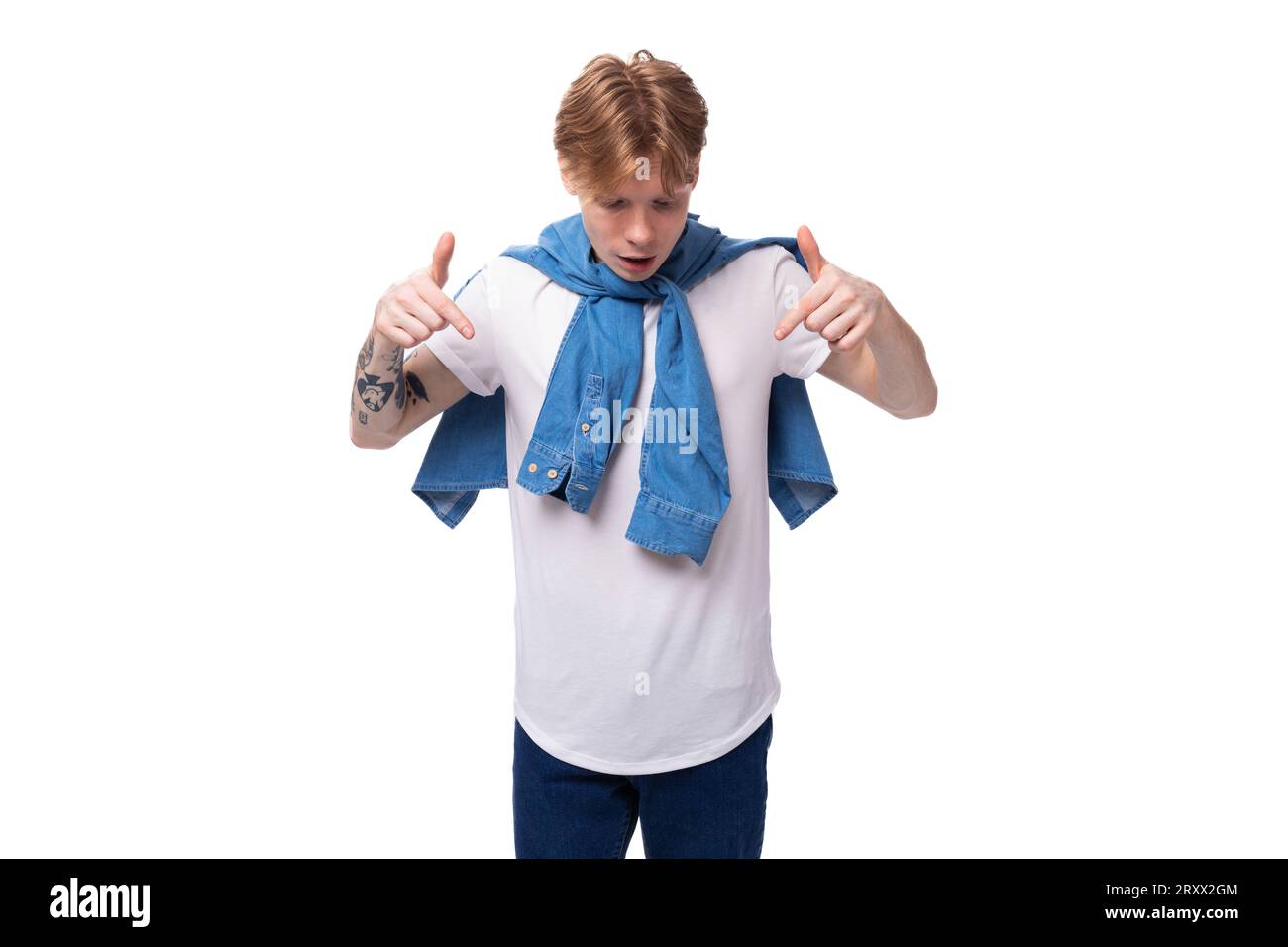 young emotional handsome slender red-haired man with a tattoo on his ...