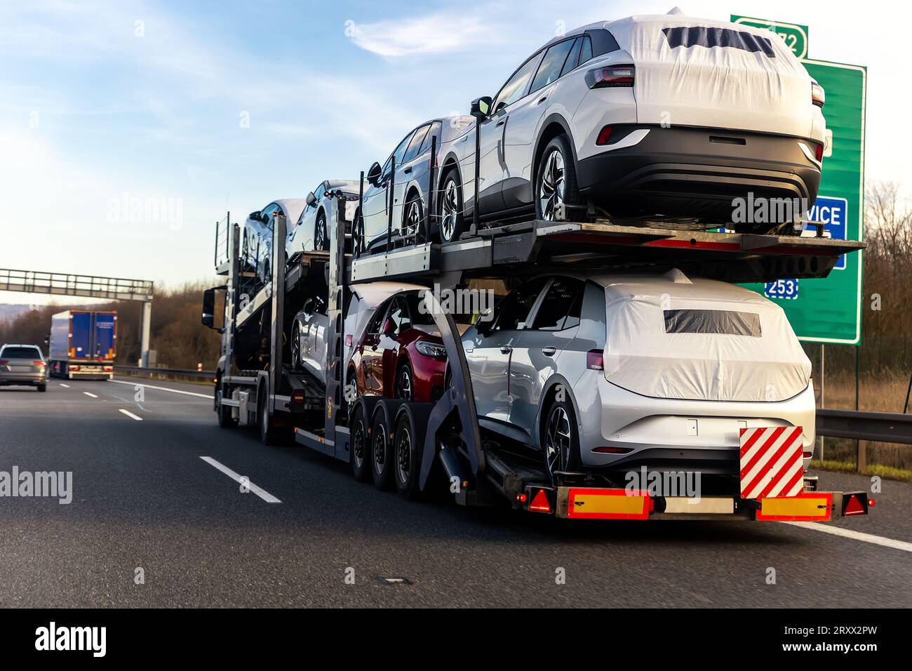Tow truck car carrier semi trailer on highway carrying batch of new ...