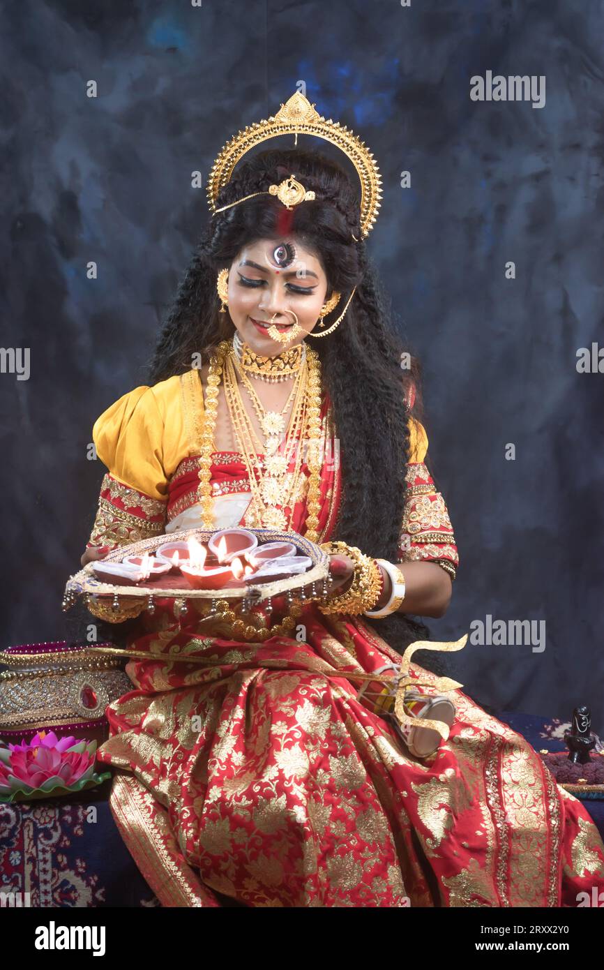 Portrait of beautiful Indian girl of Durga Idol Agomoni Concept Indoor ...