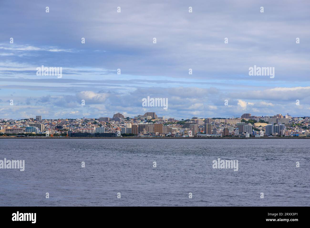 View from water of houses and apartment buildings in small coastal town ...