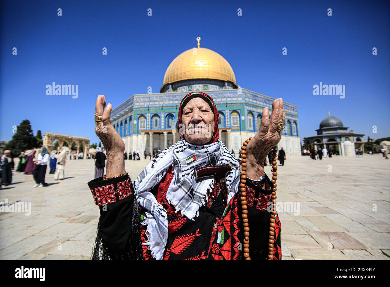 An elderly Palestinian lady offers her prayers as she commemorates the ...