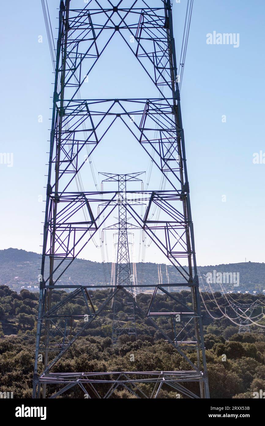 Electric cable laying towers in the forest of the Sierra de Madrid in ...