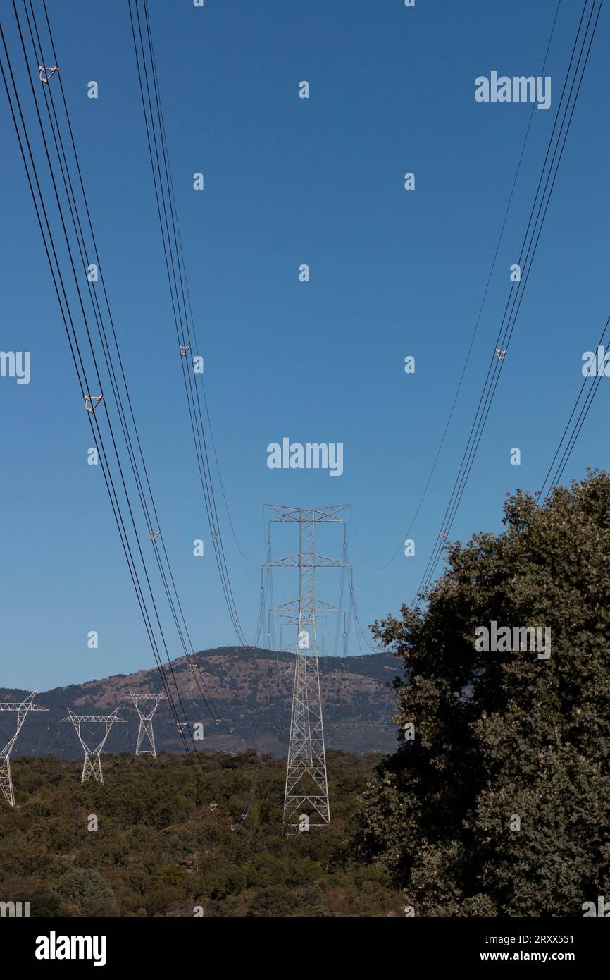 Electric cable laying towers in the forest of the Sierra de Madrid in ...