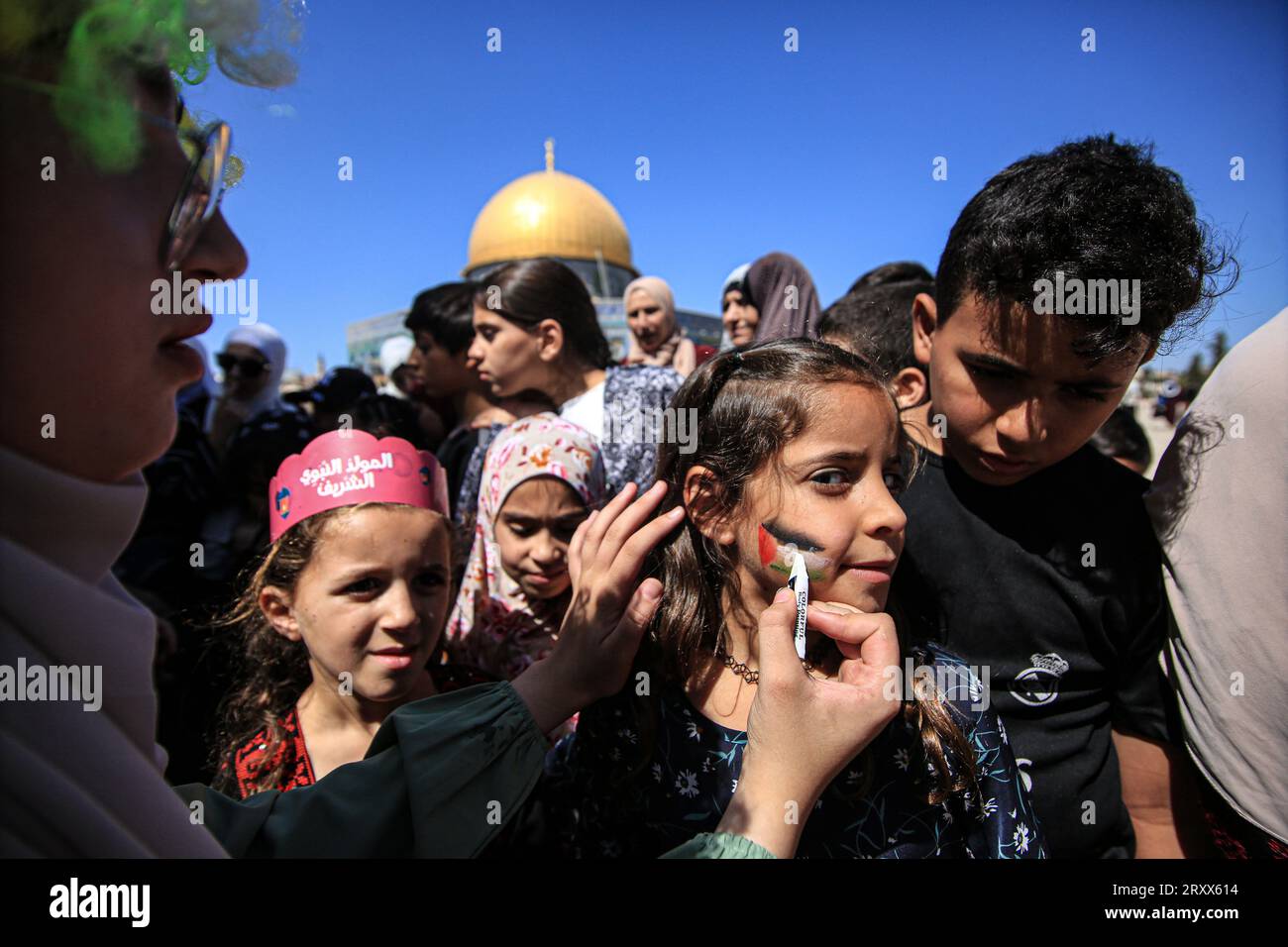 A Palestinian kid seen being face painted during the gather to ...