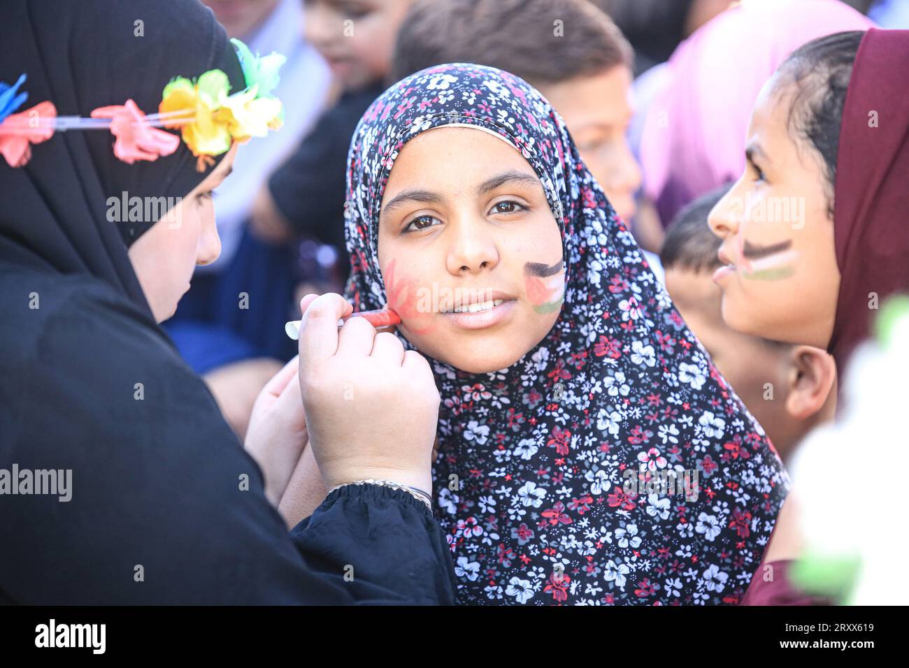 A Palestinian kid seen being face painted during the gather to ...