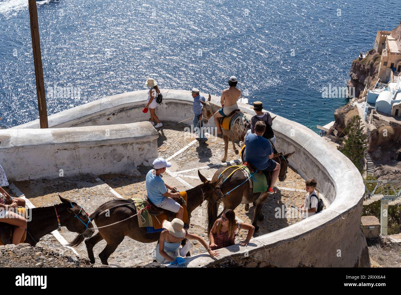 Santorini Greece - 20 September 2023: Tourists riding traditional ...