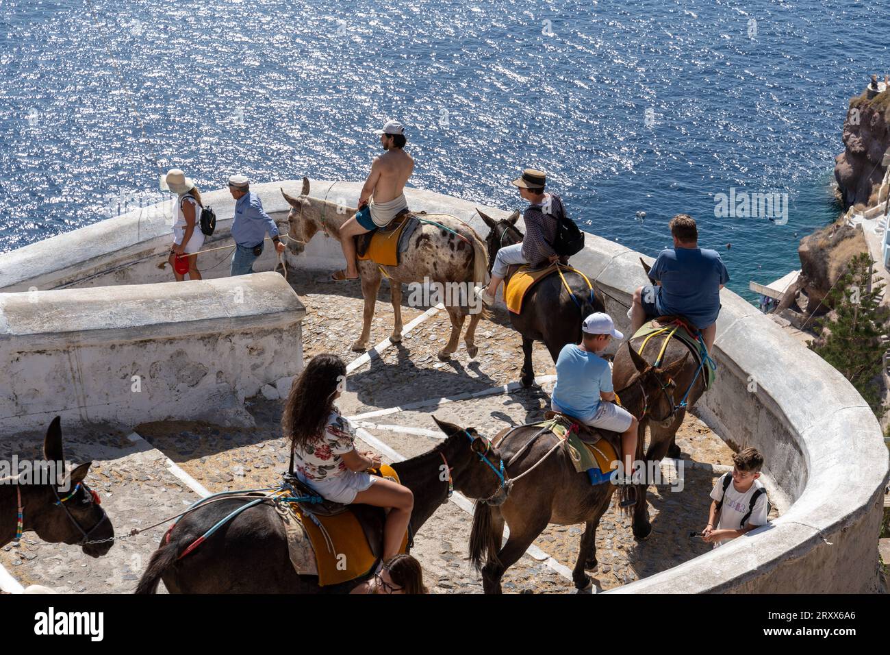 Santorini Greece - 20 September 2023: Tourists riding traditional ...