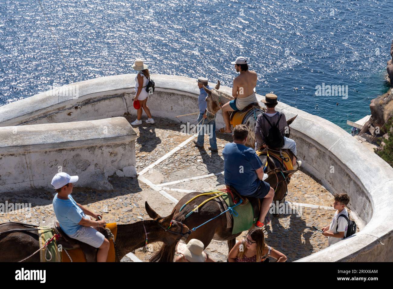 Santorini Greece - 20 September 2023: Tourists riding traditional ...