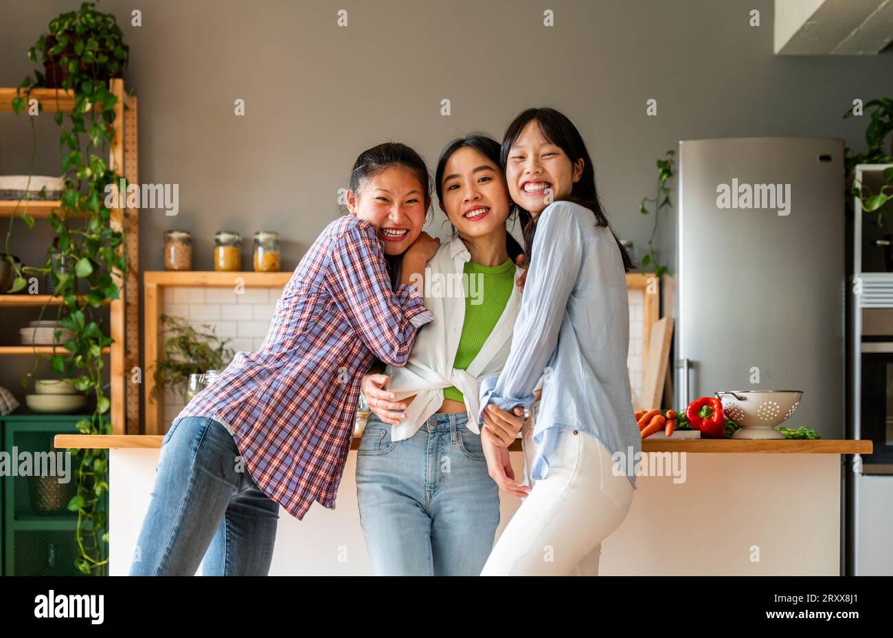 Happy beautiful chinese women friends bonding at home - Playful pretty ...