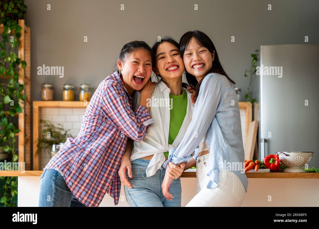 Happy beautiful chinese women friends bonding at home - Playful pretty ...
