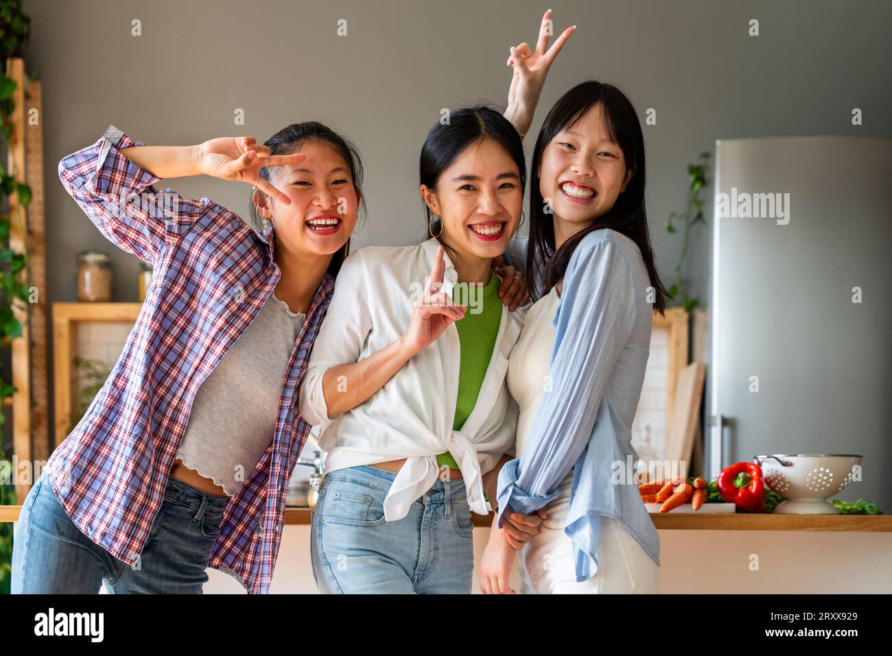 Happy beautiful chinese women friends bonding at home - Playful pretty ...