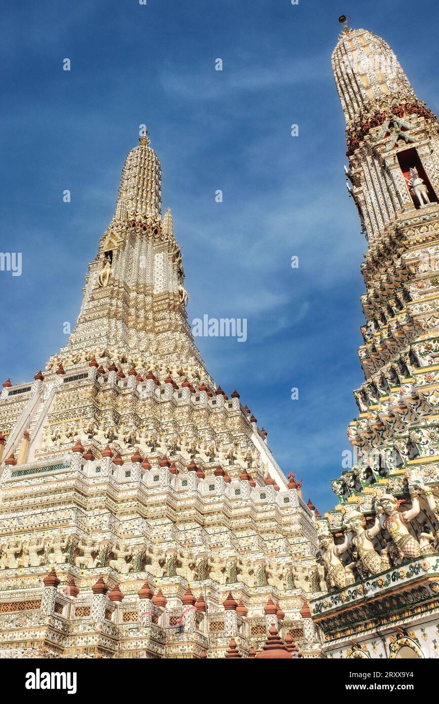 Two temple spires in Thailand. The spires are tall and ornate, with ...