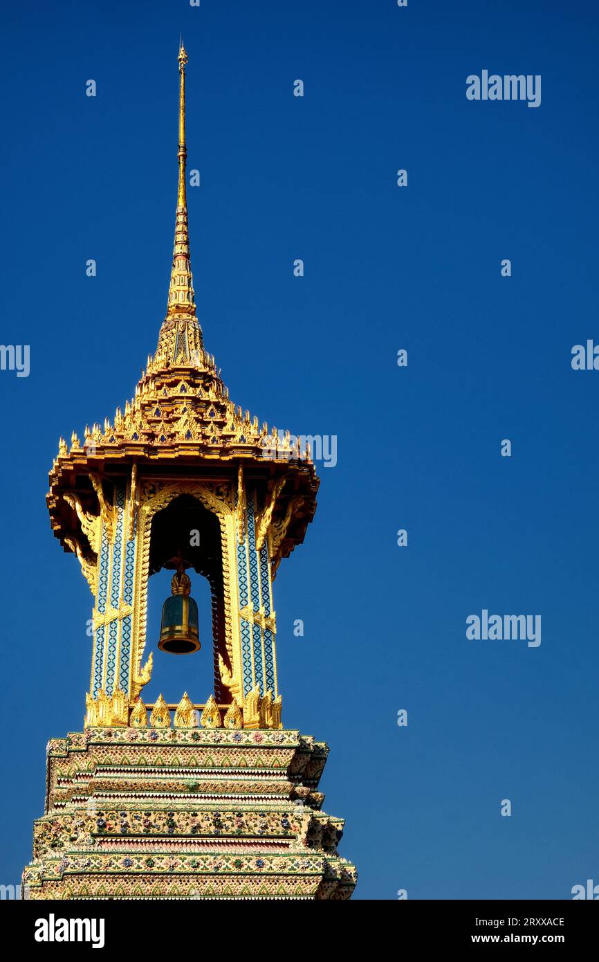 An intricate bell tower of a Thai temple, characterized by its radiant ...