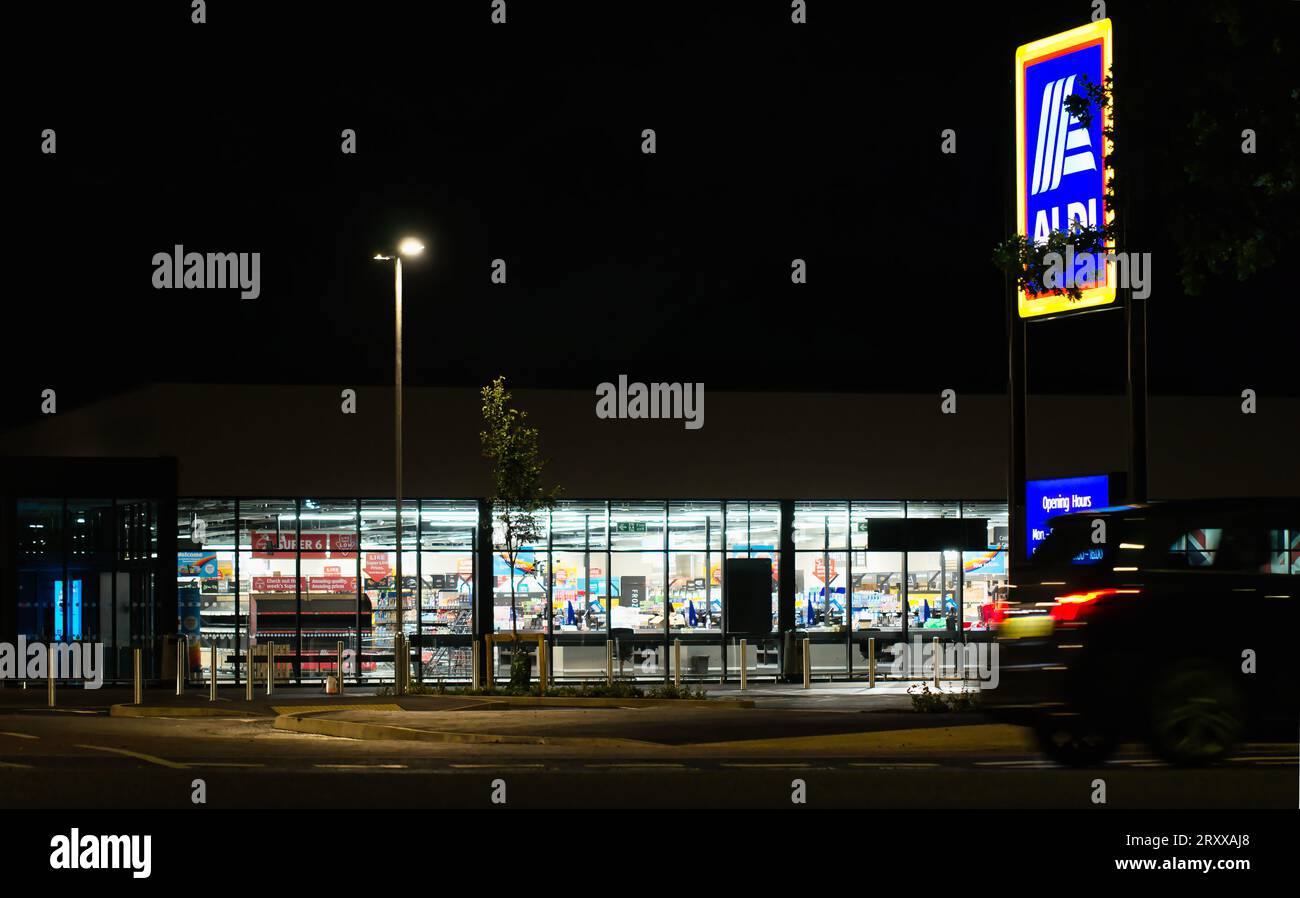 26th of September - Aldi supermarket at night time, with car passing by ...