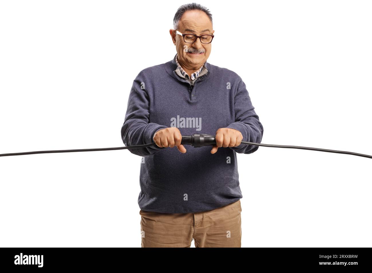 Cautious mature man plugging cables isolated on white background Stock ...