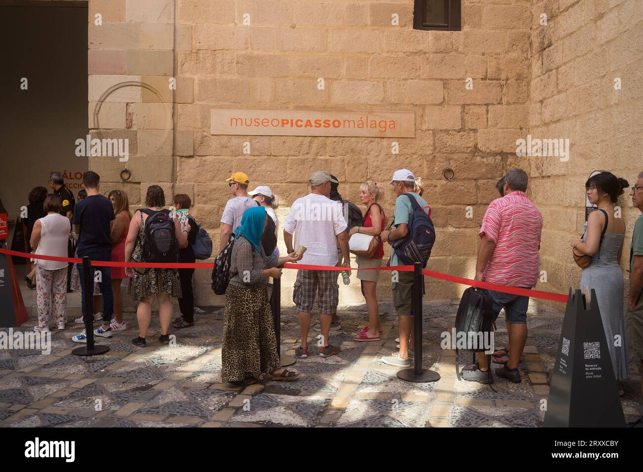 Tourists are seen in a queue outside the Picasso Museum as they wait to ...