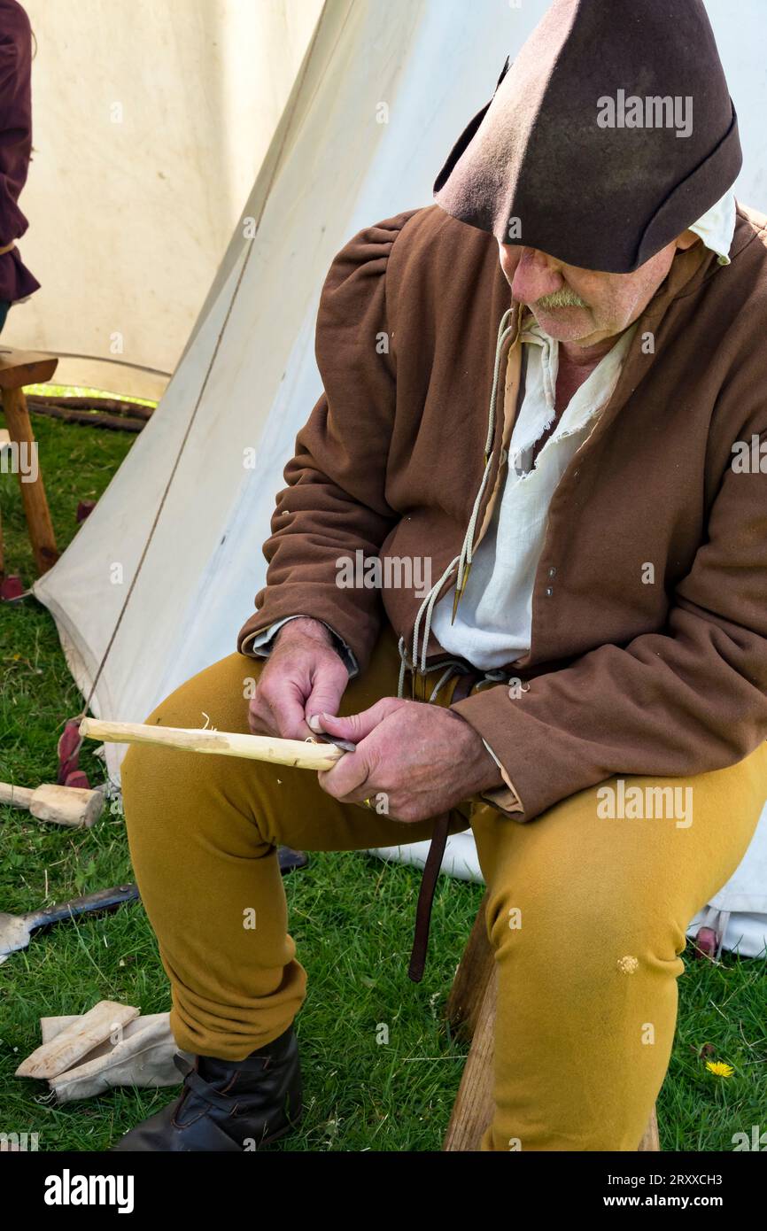 Elderly wood spoon carver in medieval costume hi-res stock photography ...