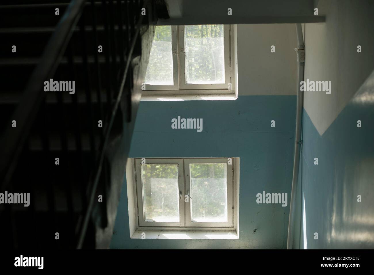 Interior with windows. Staircase inside the building. Two old windows ...
