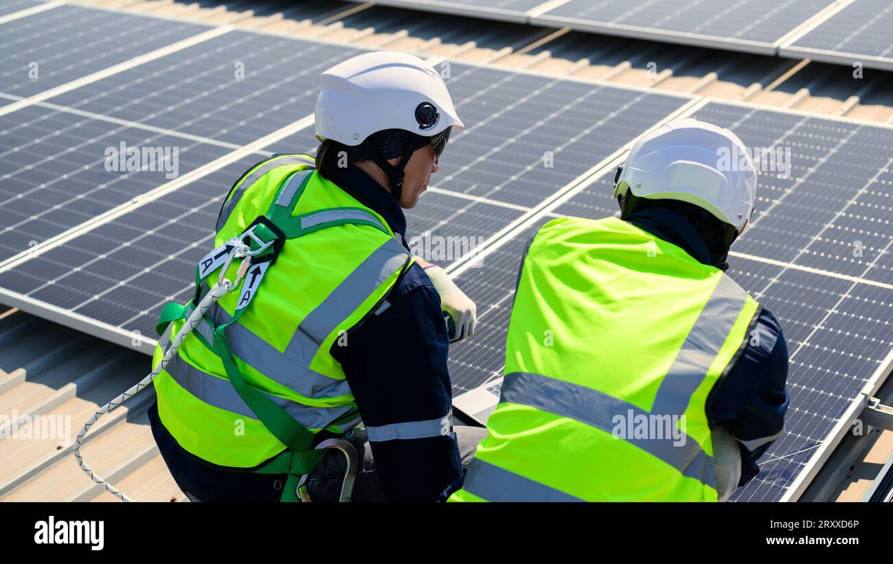 Engineers with safety helmet checking solar system at solar power farm ...