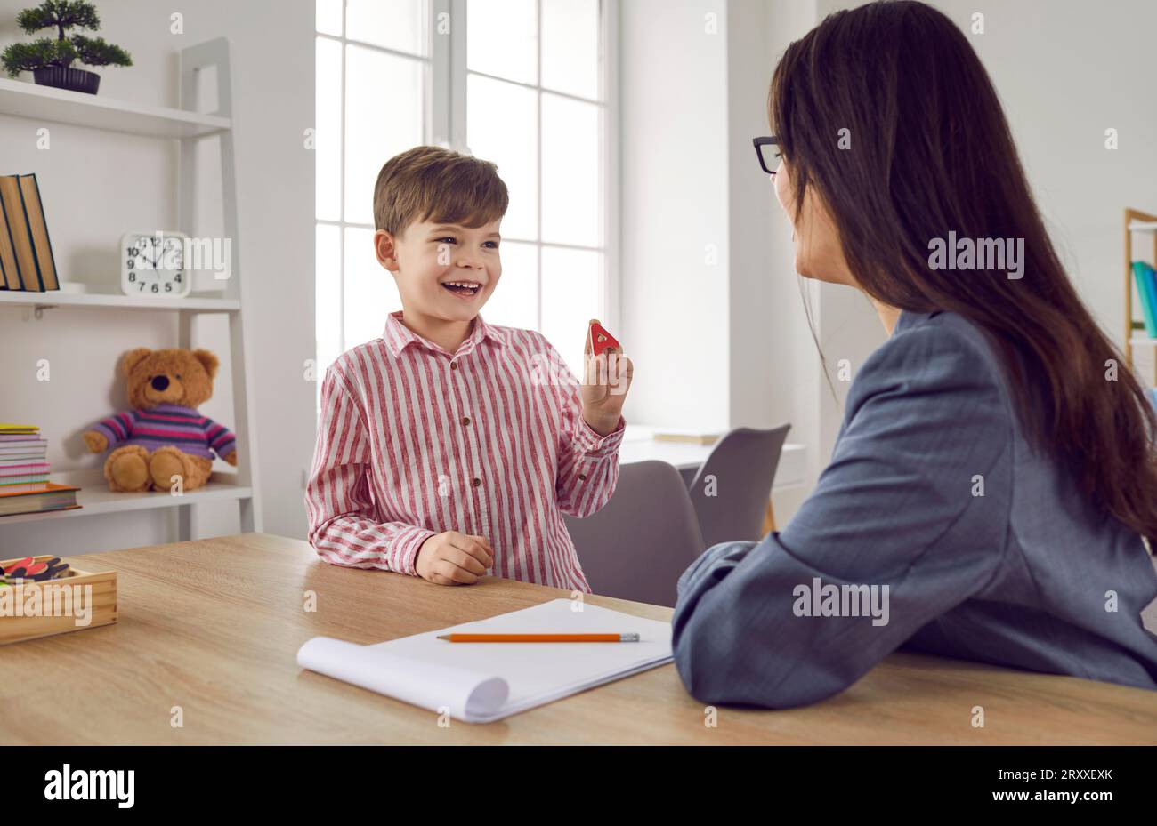 Female speech therapist with a little boy patient practicing private ...
