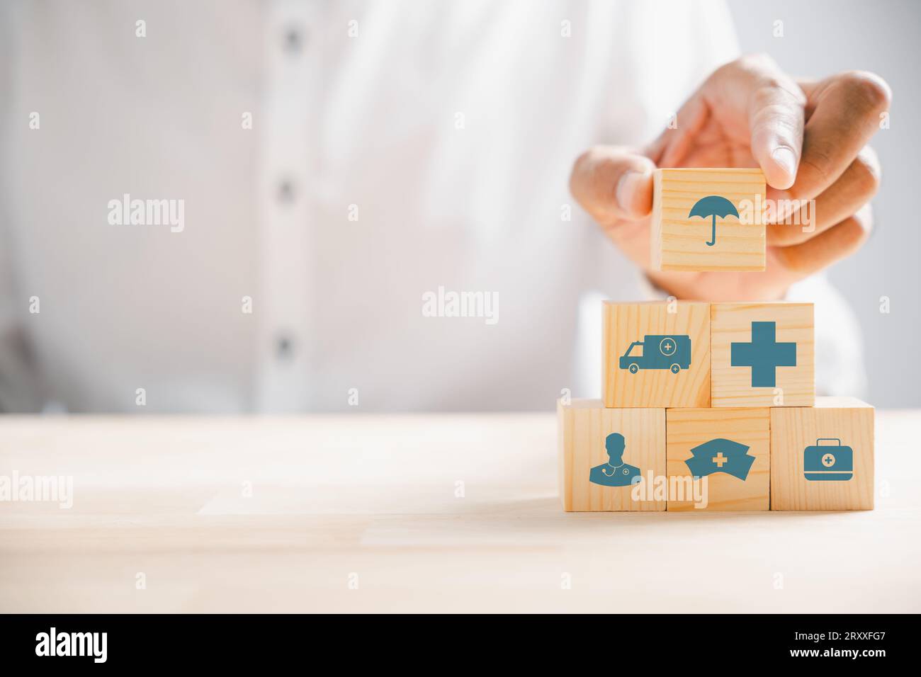 Hand hold wooden block with icon healthcare medical Stock Photo - Alamy