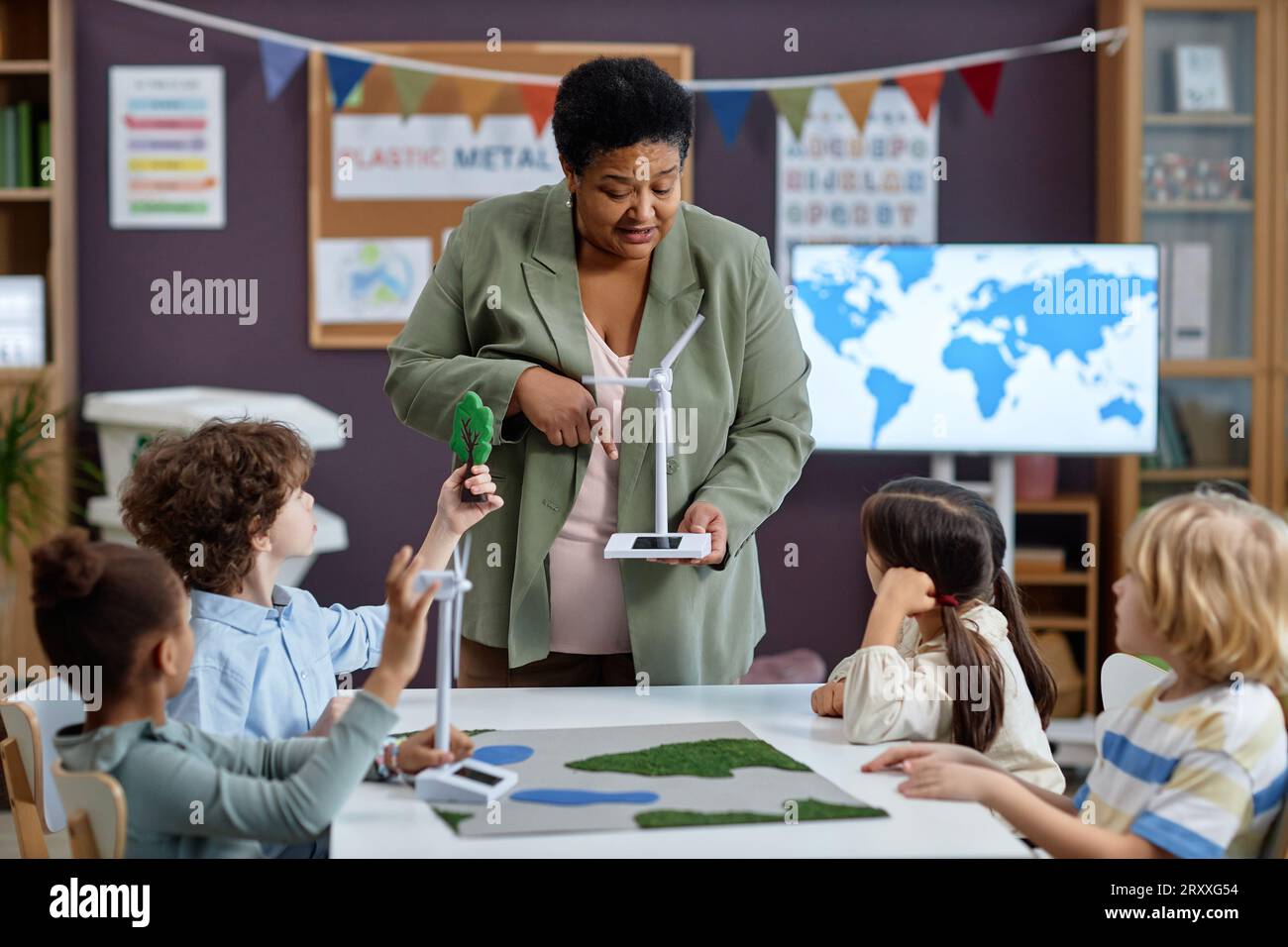 Waist up portrait of Black woman holding wind turbine model teaching ...
