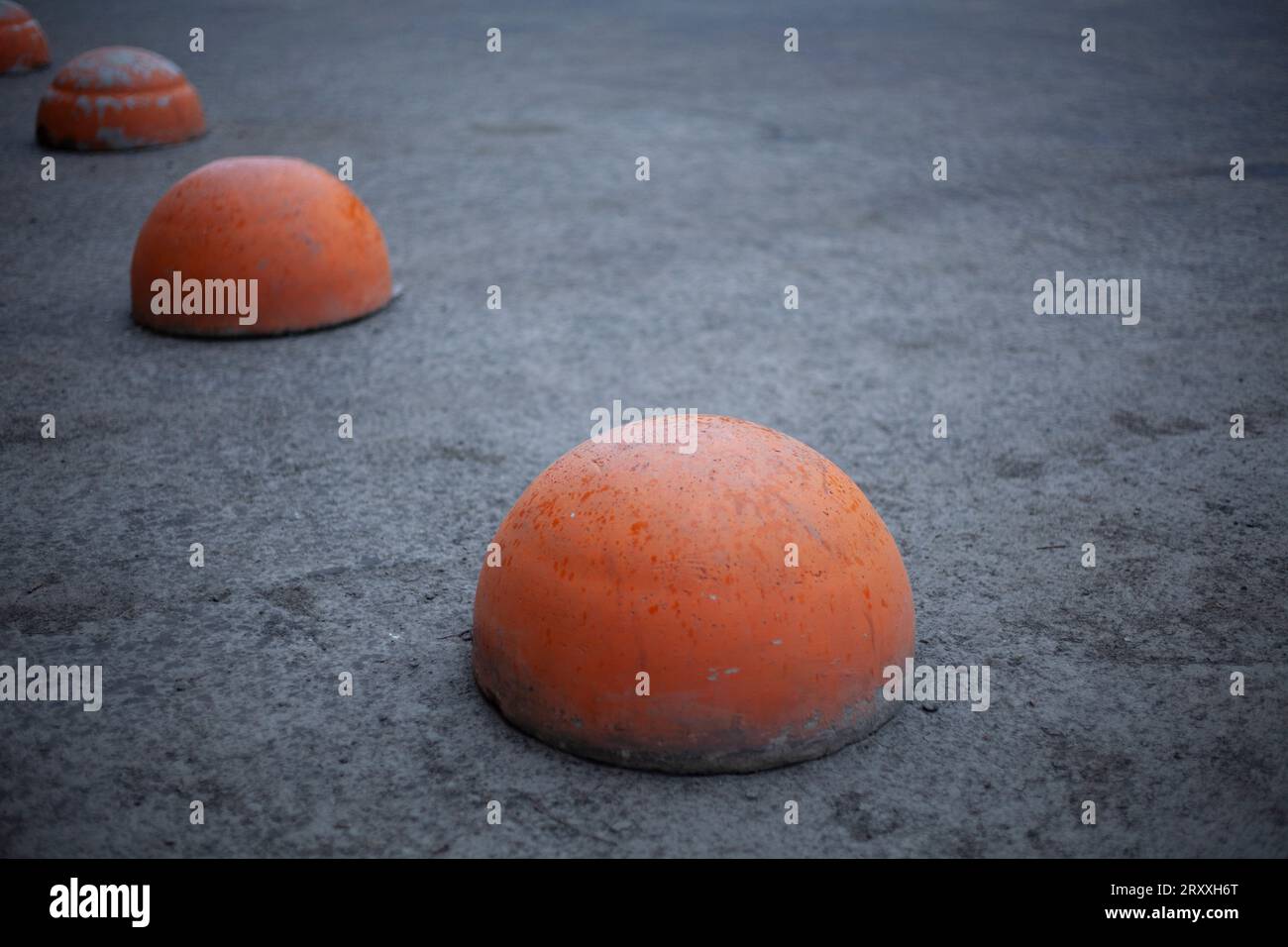 Sphere in the parking lot. Motion limiter. Orange sphere on asphalt ...
