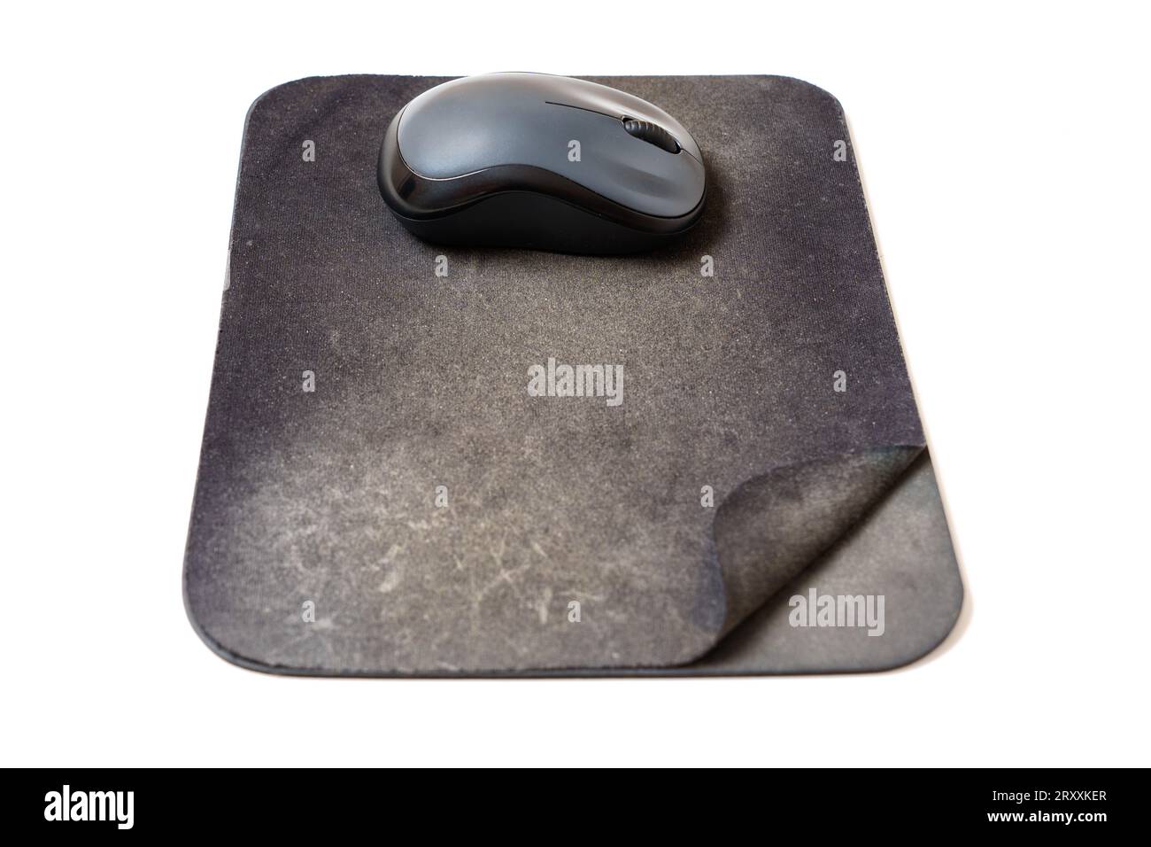 Computer mouse placed on an aged and well-worn mouse pad isolated on ...