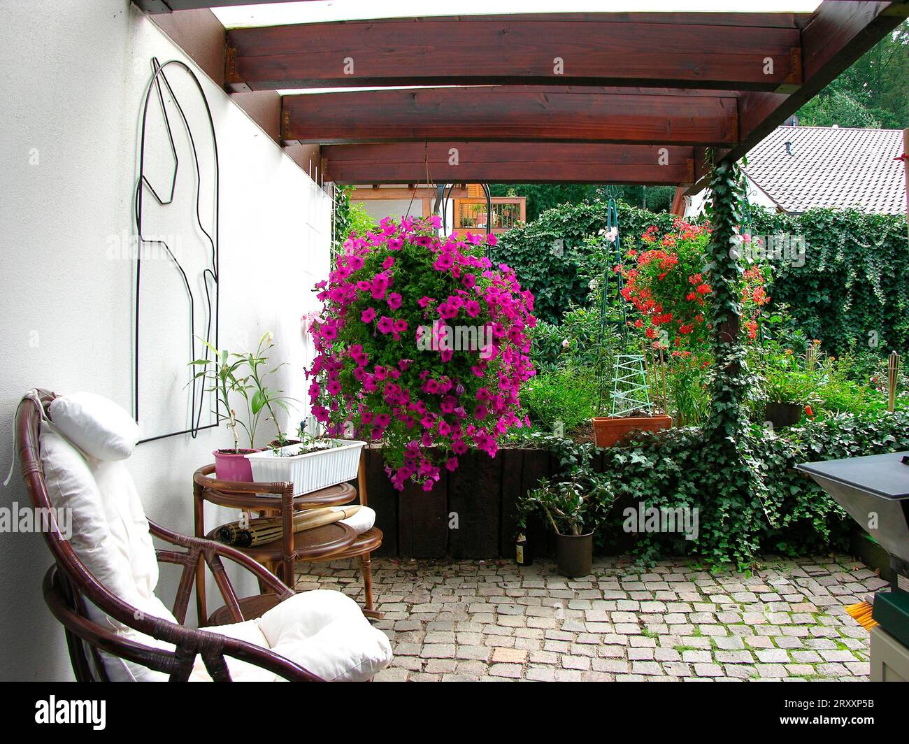 Paved garden terrace with chairs Stock Photo - Alamy